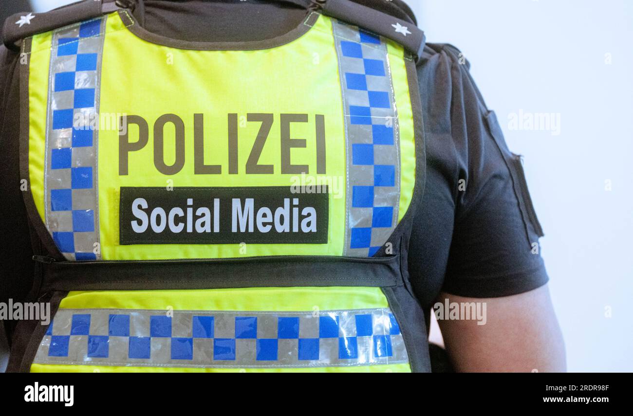 Hamburg, Germany. 20th July, 2023. A police officer wears a vest with ...