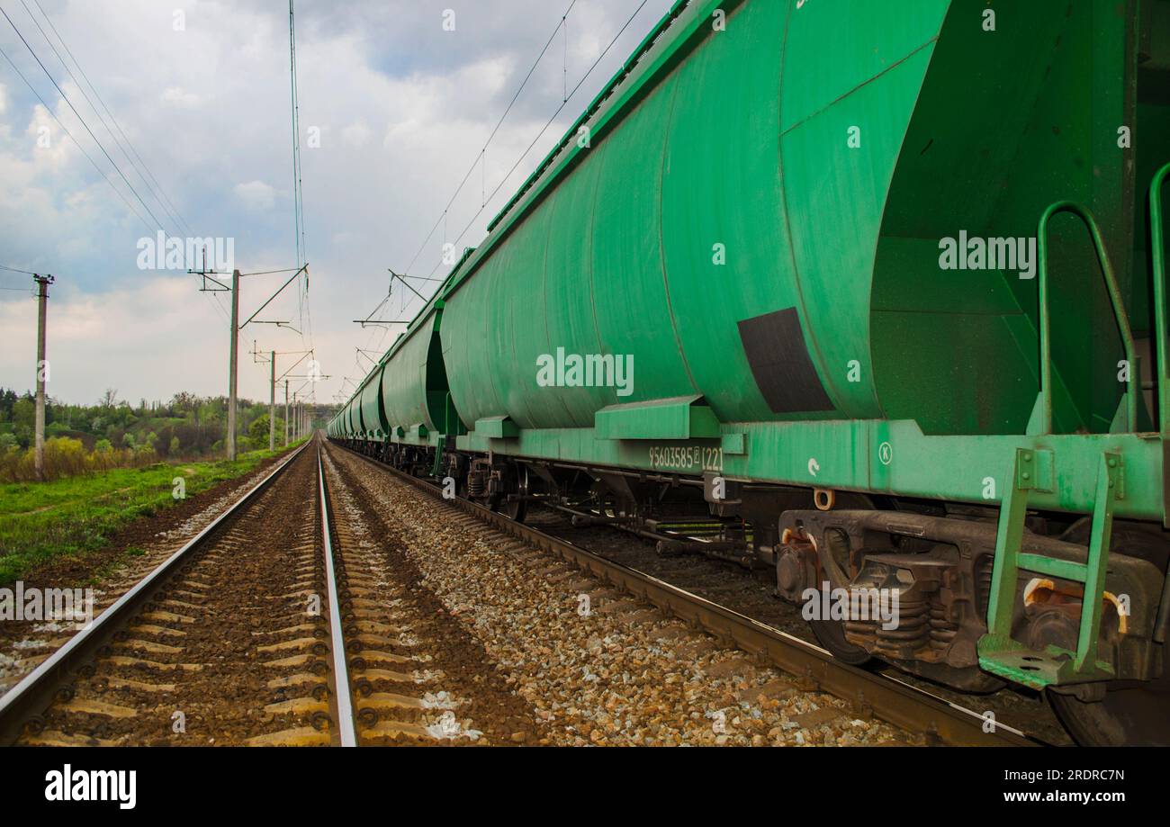 Green wagons as part of a freight train on rails Stock Photo - Alamy
