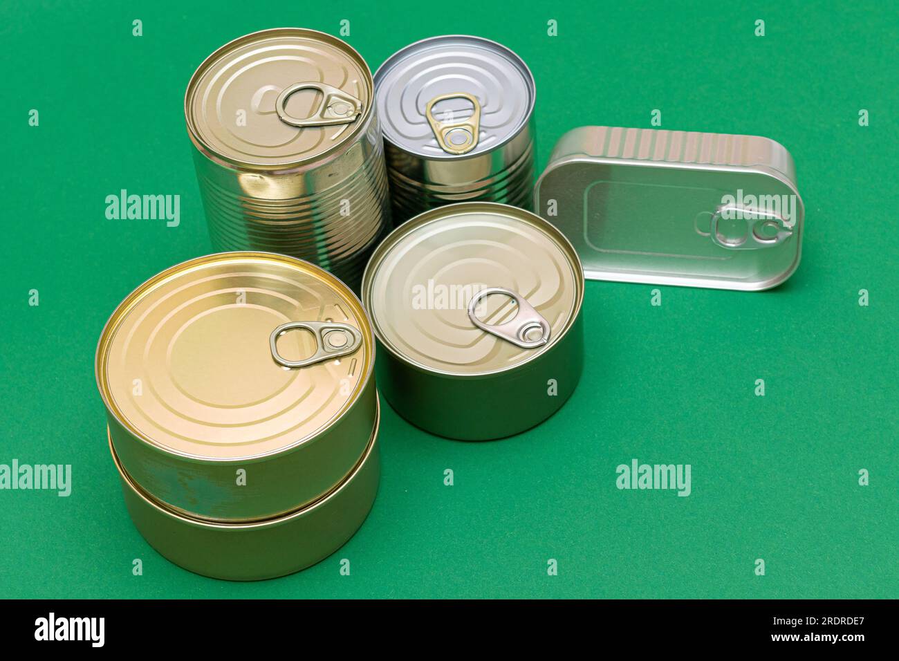 A Group of Stacked Tin Cans with Blank Edges on Green Background ...