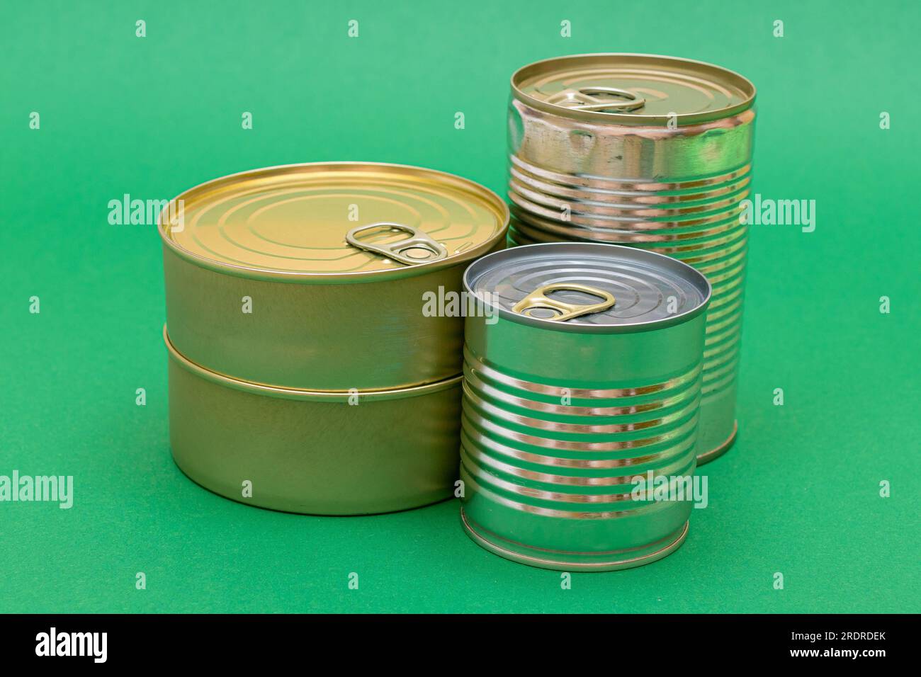 A Group of Stacked Tin Cans with Blank Edges on Green Background ...