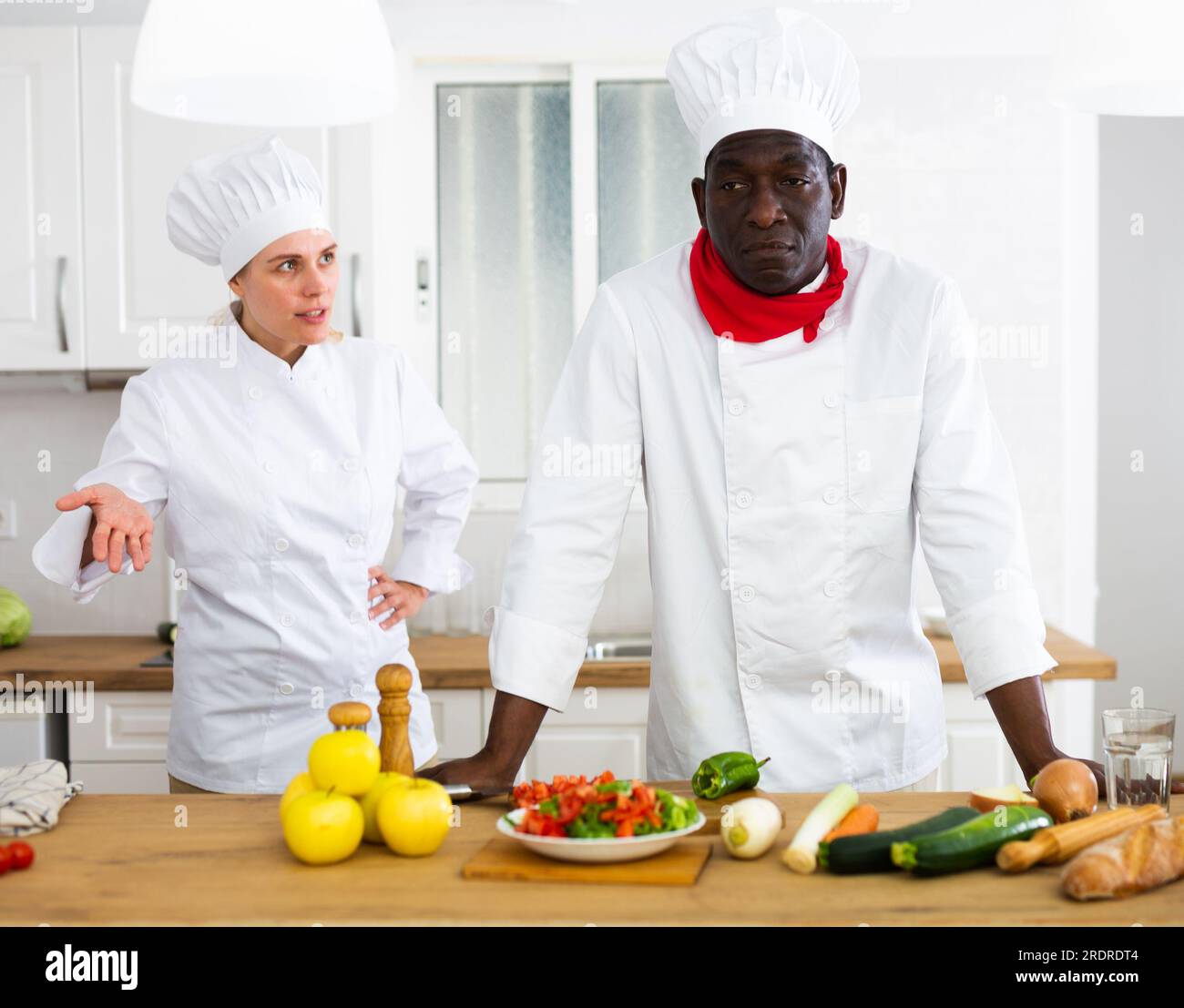 Cook and chef having quarrel in kitchen Stock Photo - Alamy
