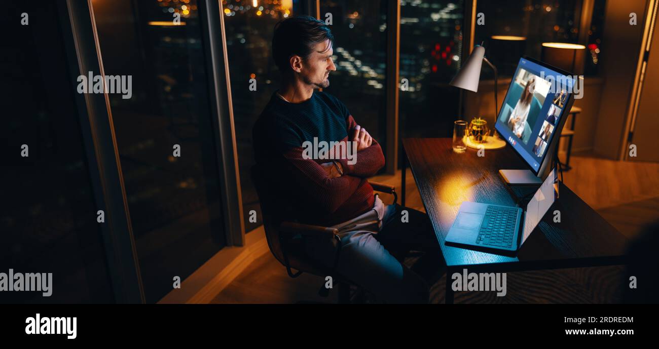 business man working late at night in an office, engaging in a video ...