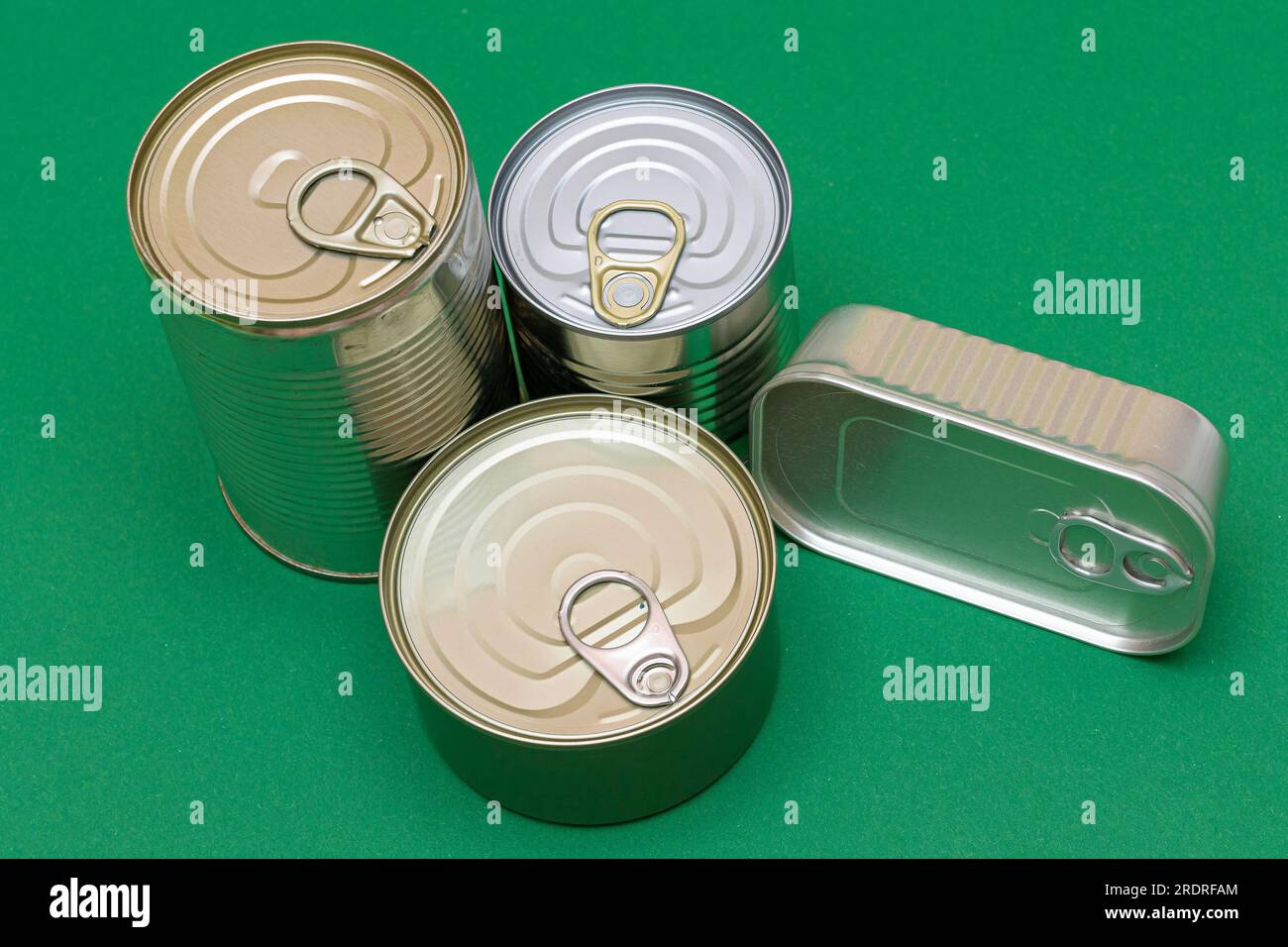 A Group of Stacked Tin Cans with Blank Edges on Green Background ...