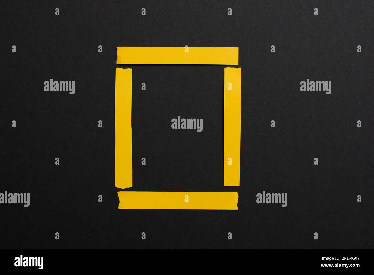Yellow square frame on black background Stock Photo - Alamy