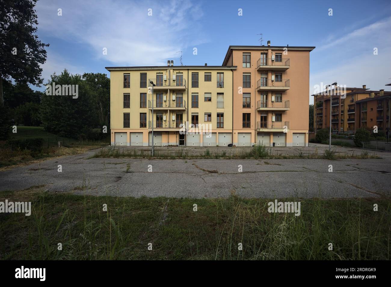 Worn building with a clearing in front of it in a residential area at ...