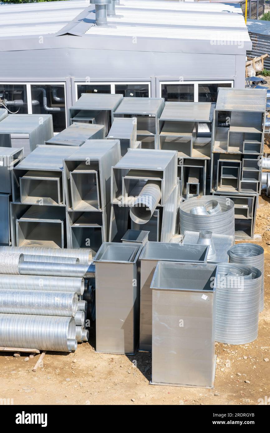 Various sheet metal air ducts in stock for installation in a building ...