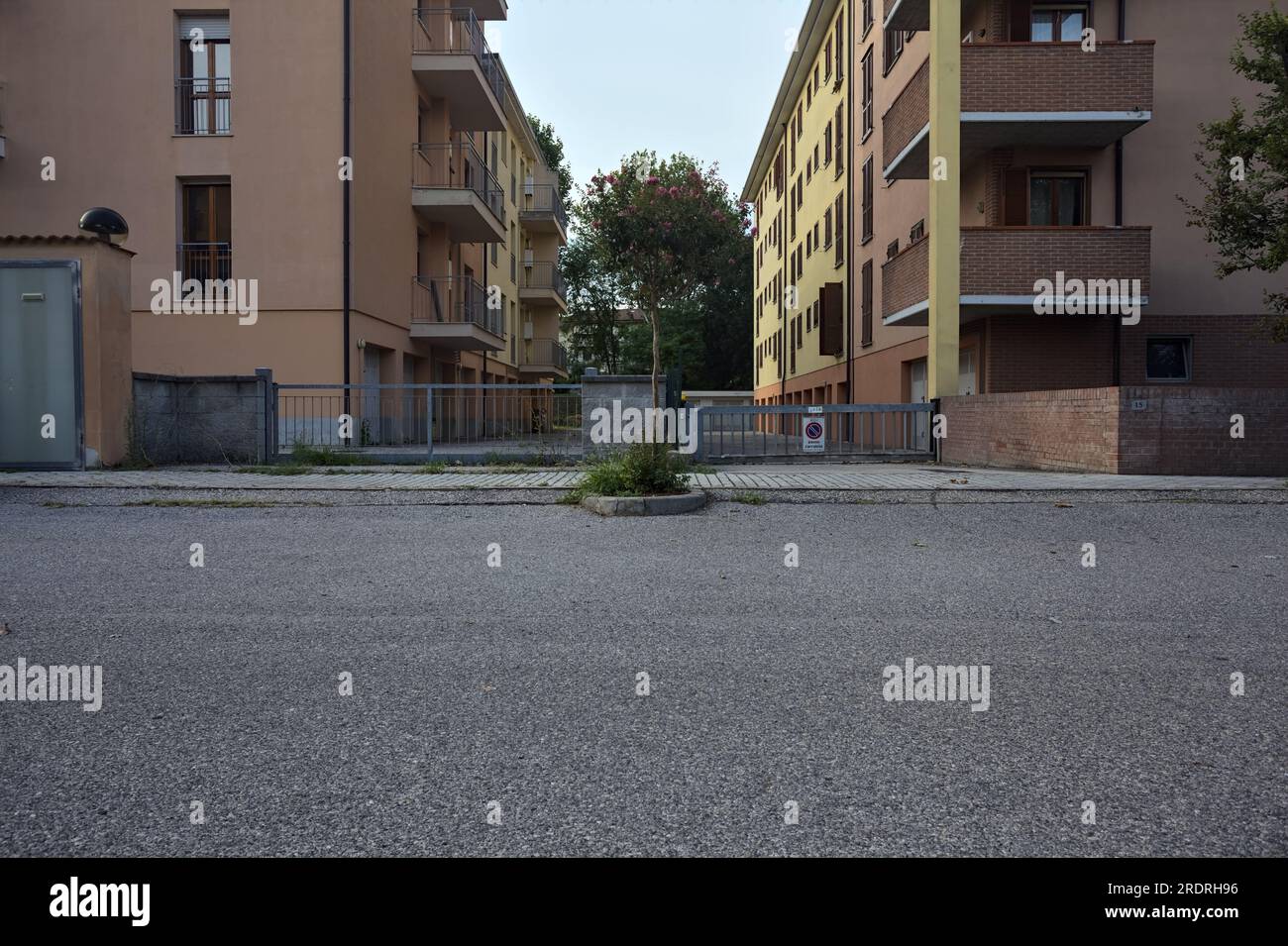 Gates and passageway between residential buildings seen from a street ...