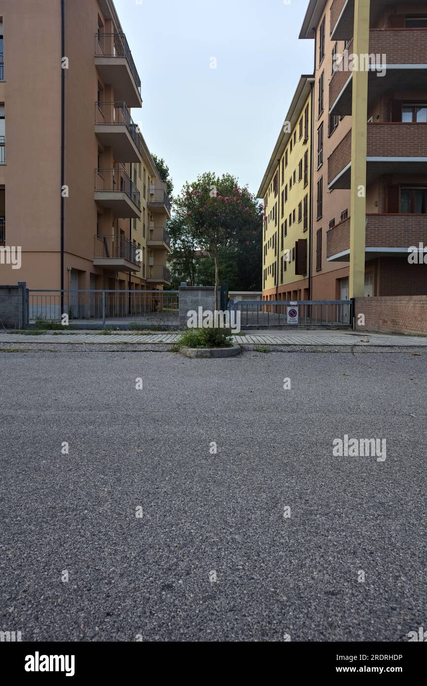 Gates and passageway between residential buildings seen from a street ...