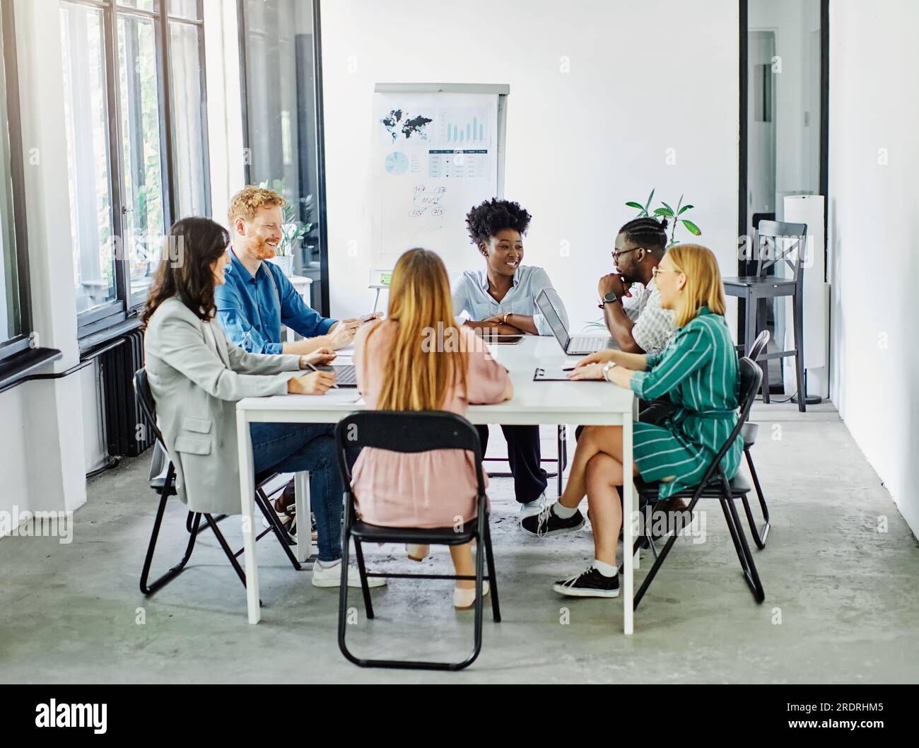 Group of young business people having a meeting or presentation and ... Group of young business people having a meeting or presentation and ...