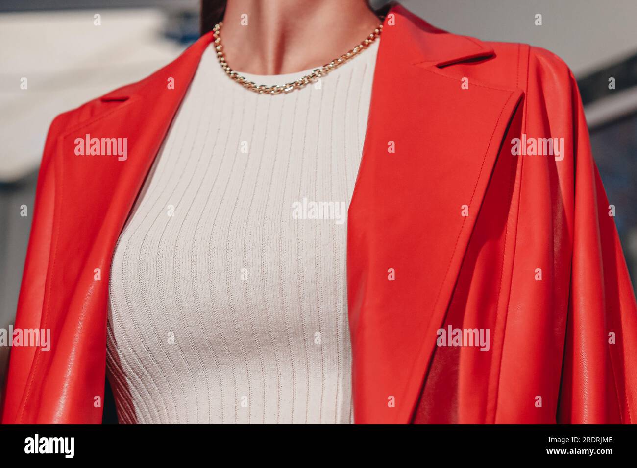 Female body in a red fancy leather jacket, white top and short skirt ...