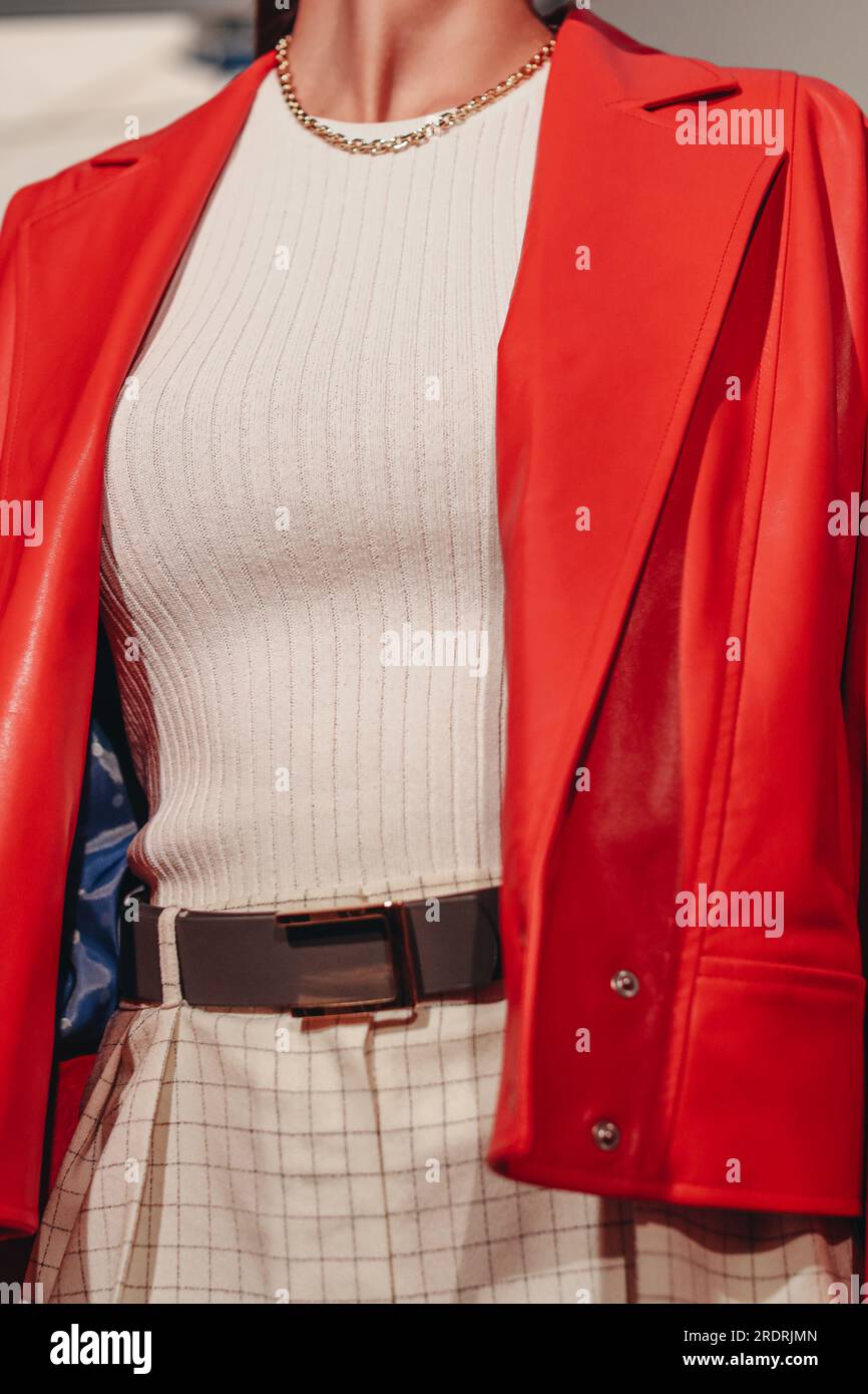 Female body in a red fancy leather jacket, white top and short skirt ...