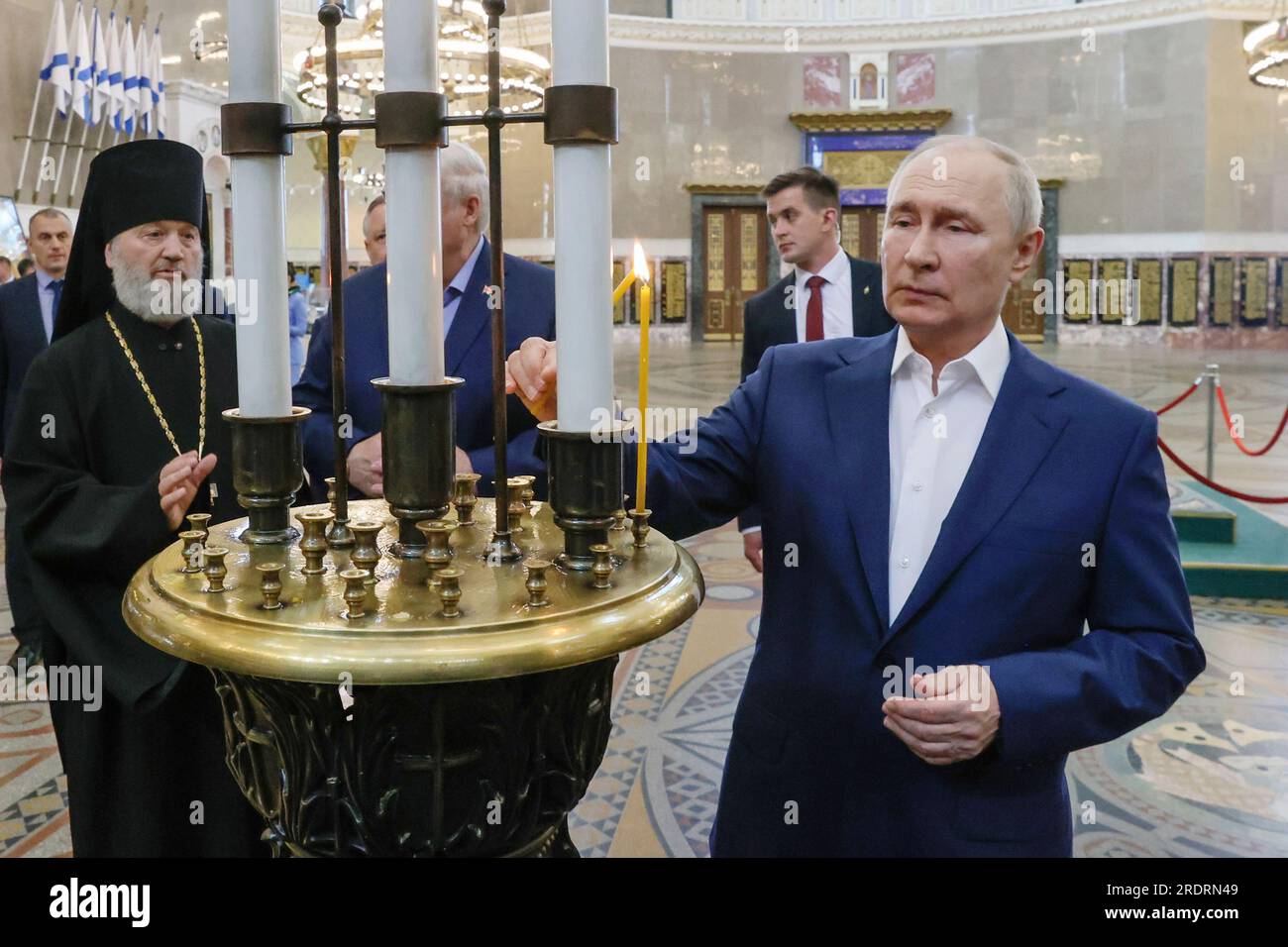 Russian President Vladimir Putin lights a candle as he visits the Naval ...