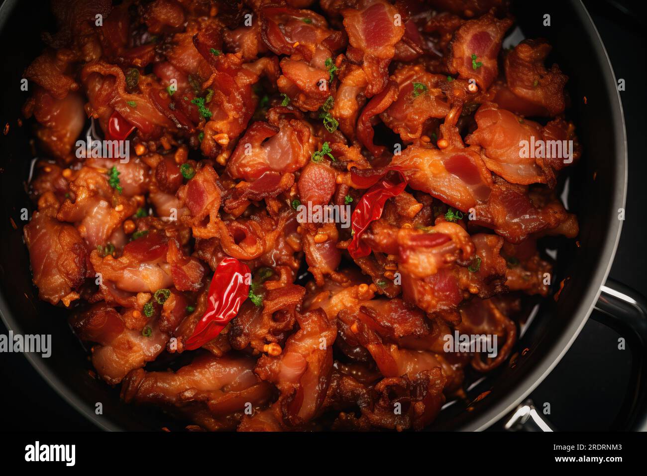 Meat sizzling in a pan Stock Photo - Alamy