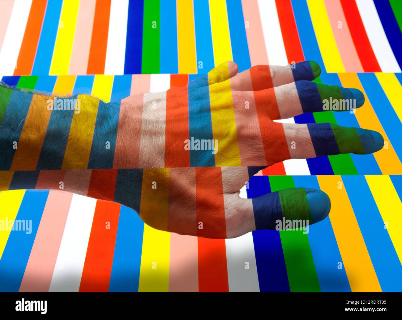 A hand showing a colorful striped background in transparency Stock ...