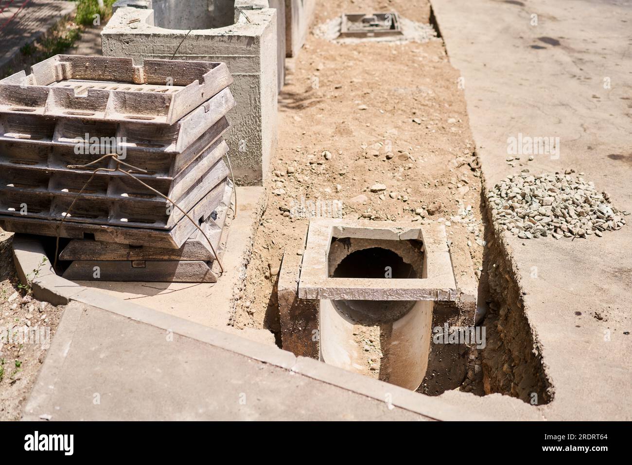 Laying concrete manholes and drain pipes for stormwater system ...
