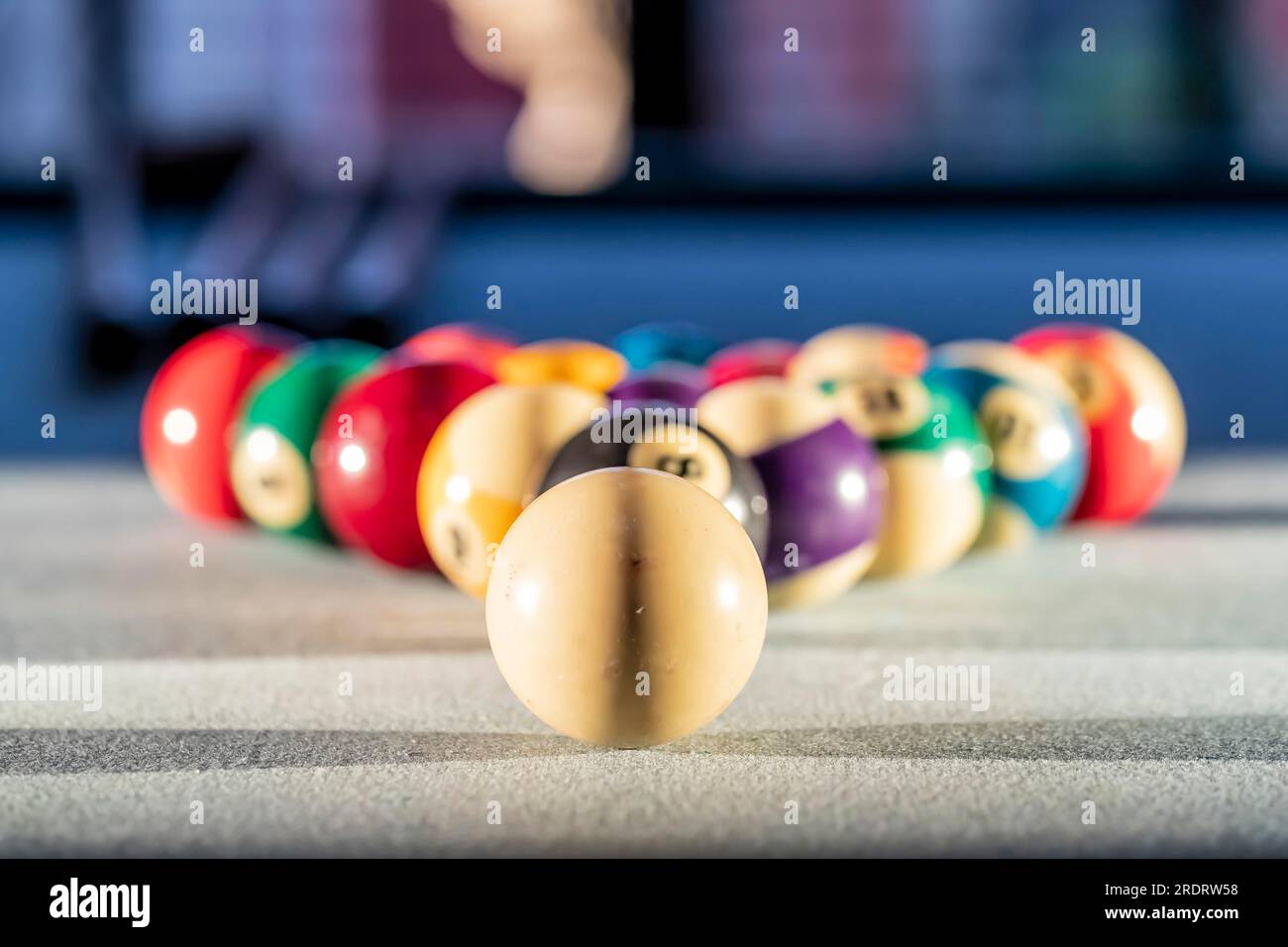 A racked up triangle of billiard balls on the table, ready for a game ...