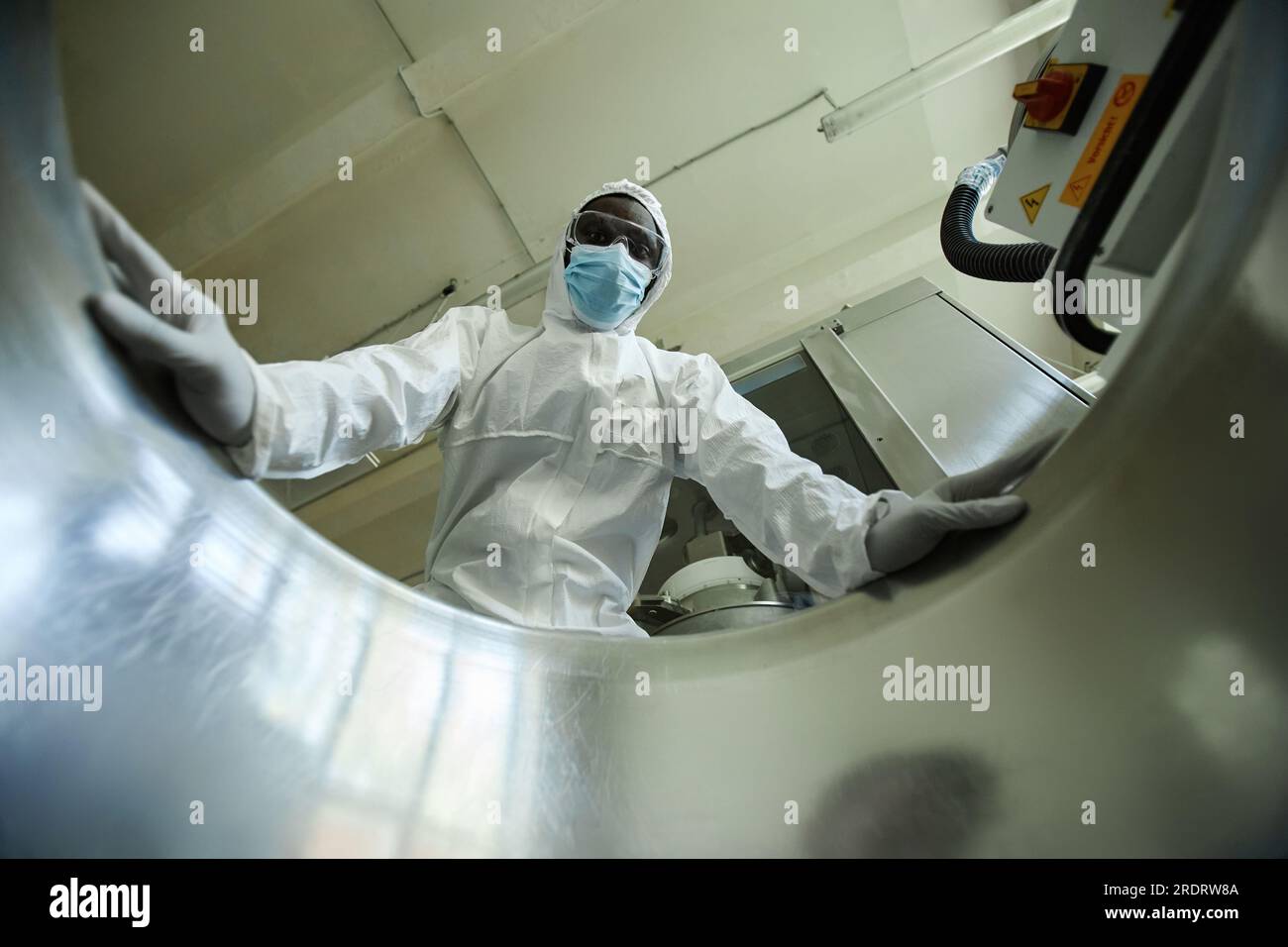 Low angle shot of black man wearing protective suit looking in tank ...