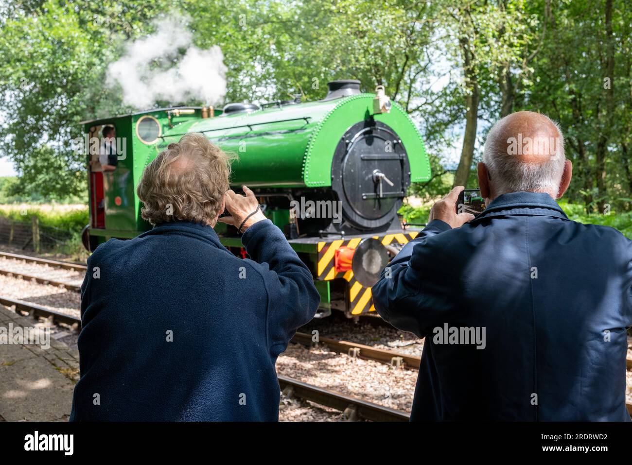 Railway enthusiasts photographing a steam engine on an English ...