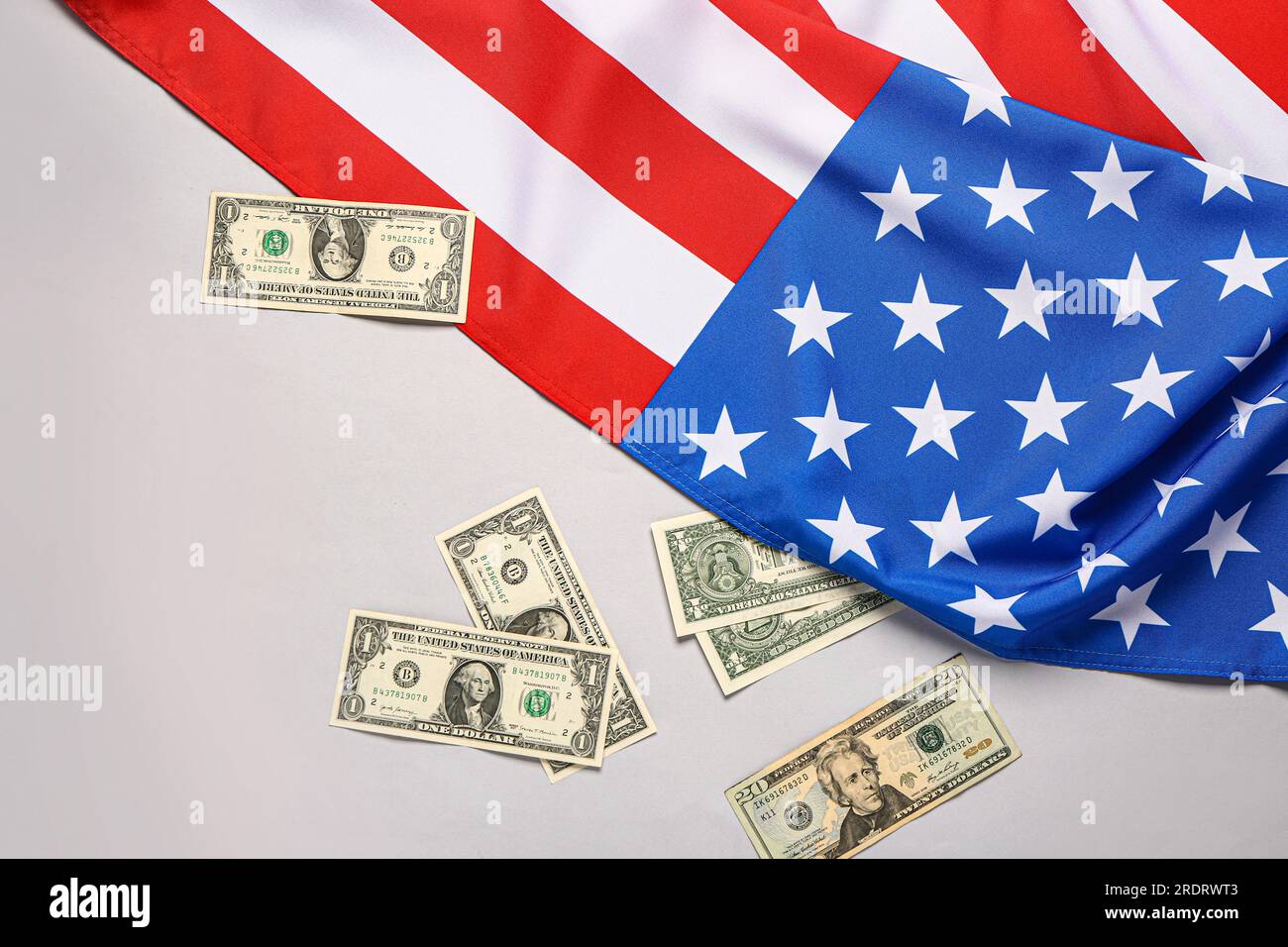 Flag of USA and dollar banknotes on grey background Stock Photo - Alamy