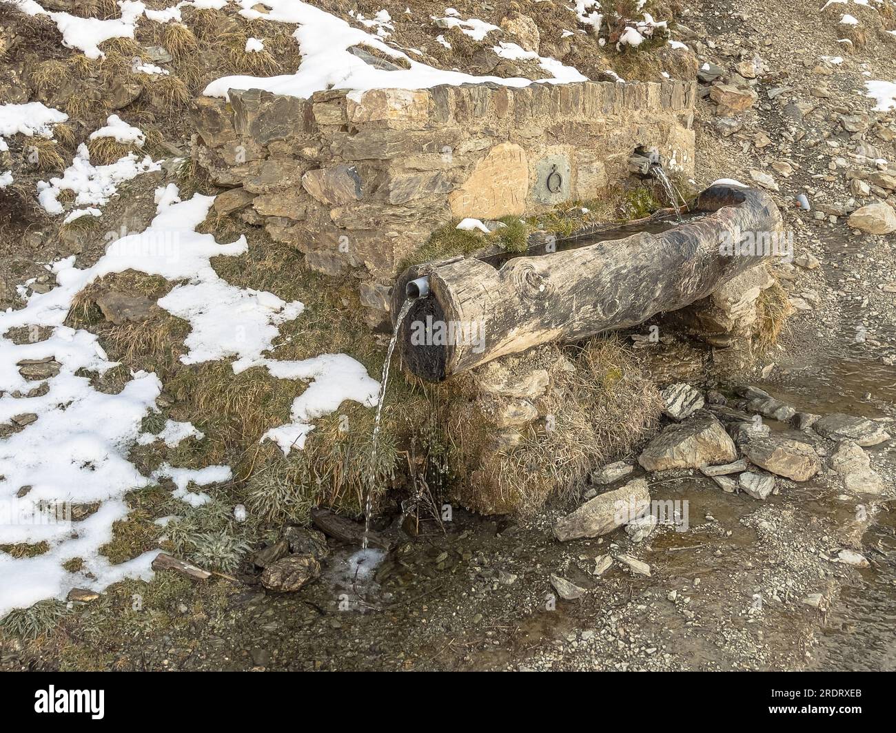Old drinking water well in trunk in the Pyrenee mountains near Queralbs ...