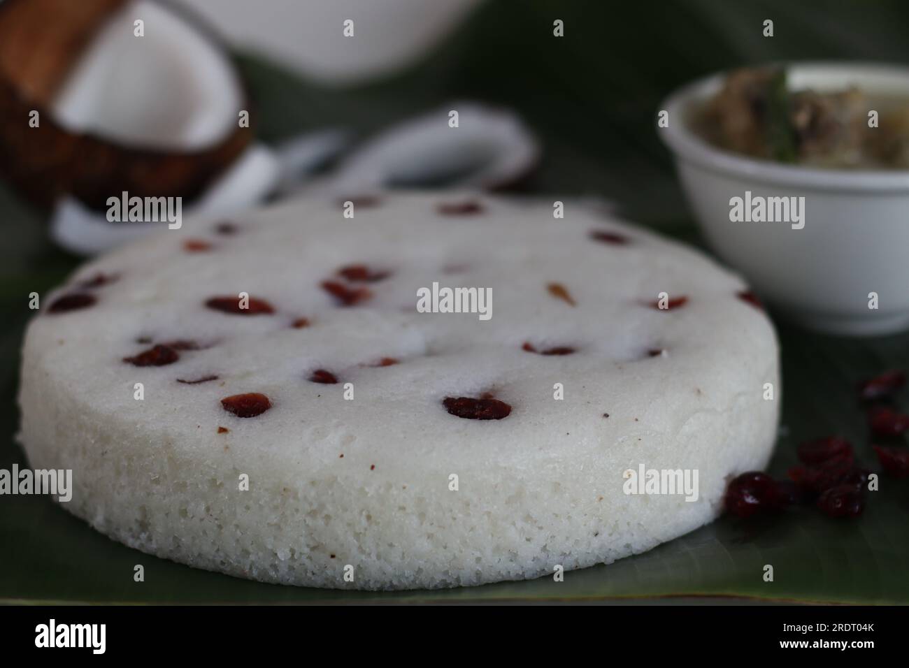 Vattayappam. Steamed spongy rice cake topped with dried cranberries. A ...