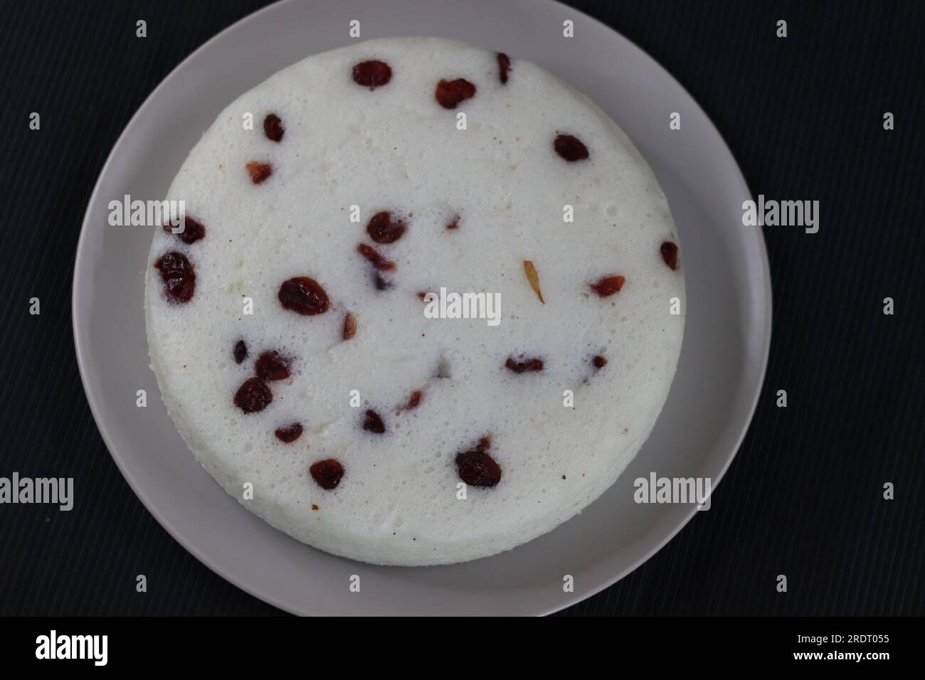 Vattayappam. Steamed spongy rice cake topped with dried cranberries. A ...