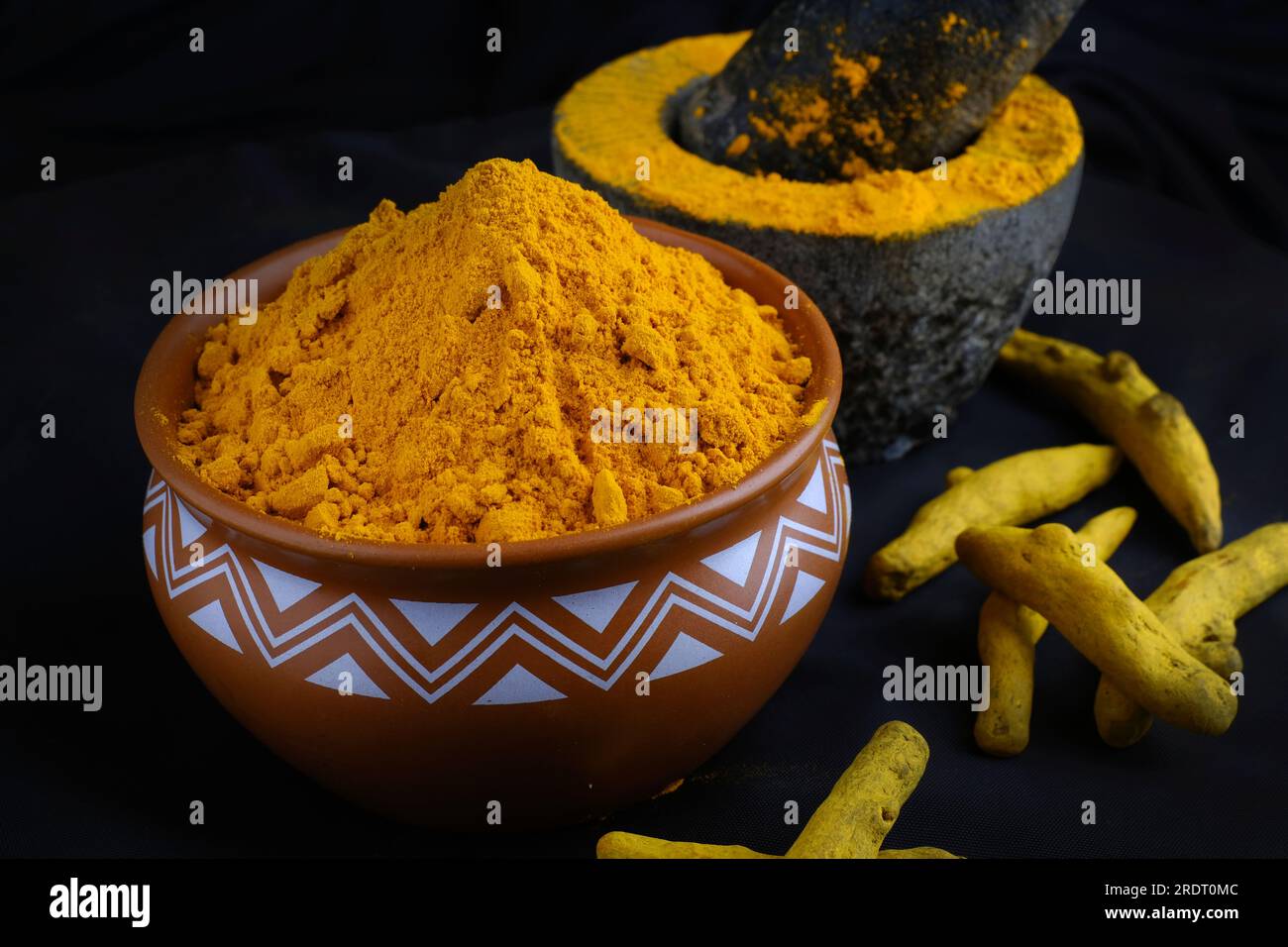 Dry turmeric powder (curcuma longa linn) stone mortar, traditional ...