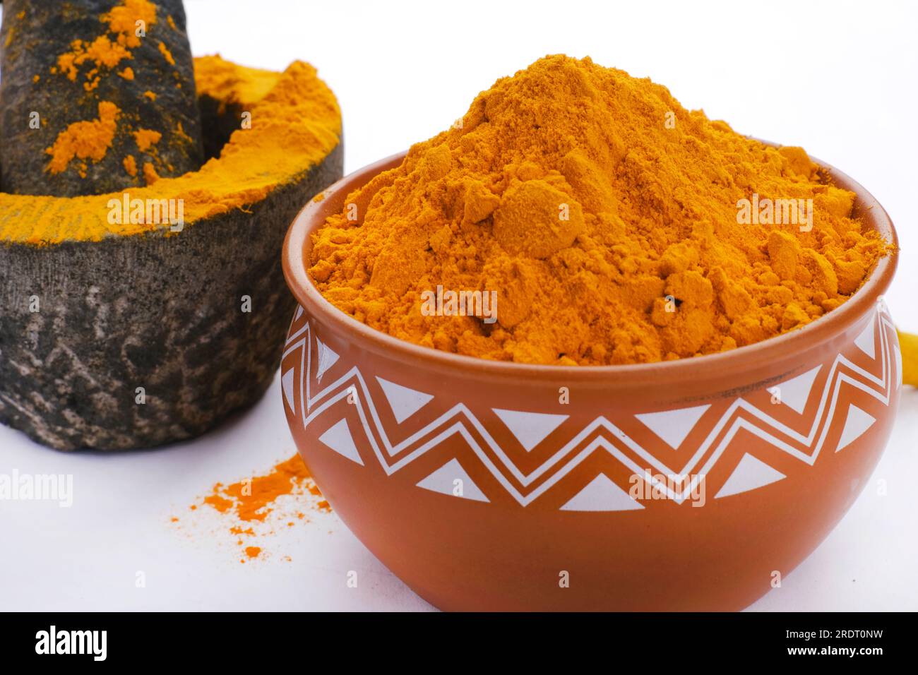 Dry turmeric powder (curcuma longa linn) stone mortar, traditional ...