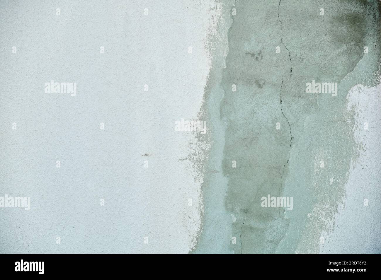 Concrete wall with crack running down repaired with gray concrete ...