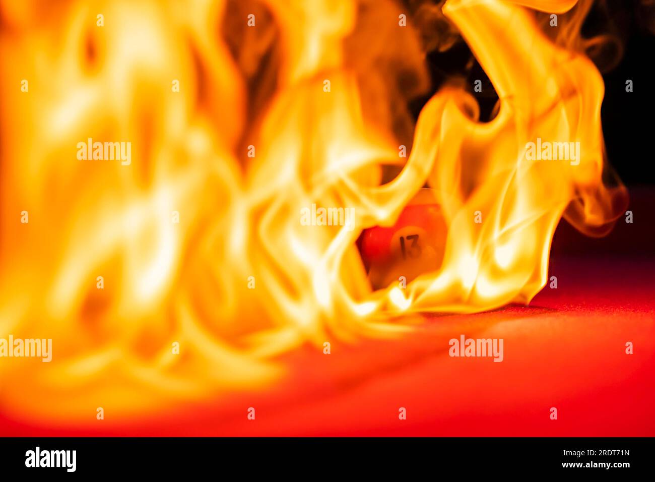 Billiard balls are photographed on fire while sitting outdoors in an ...