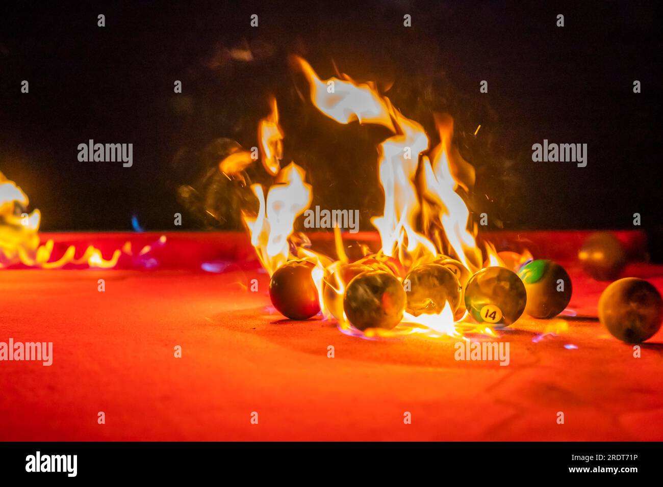 Billiard balls are photographed on fire while sitting outdoors in an ...