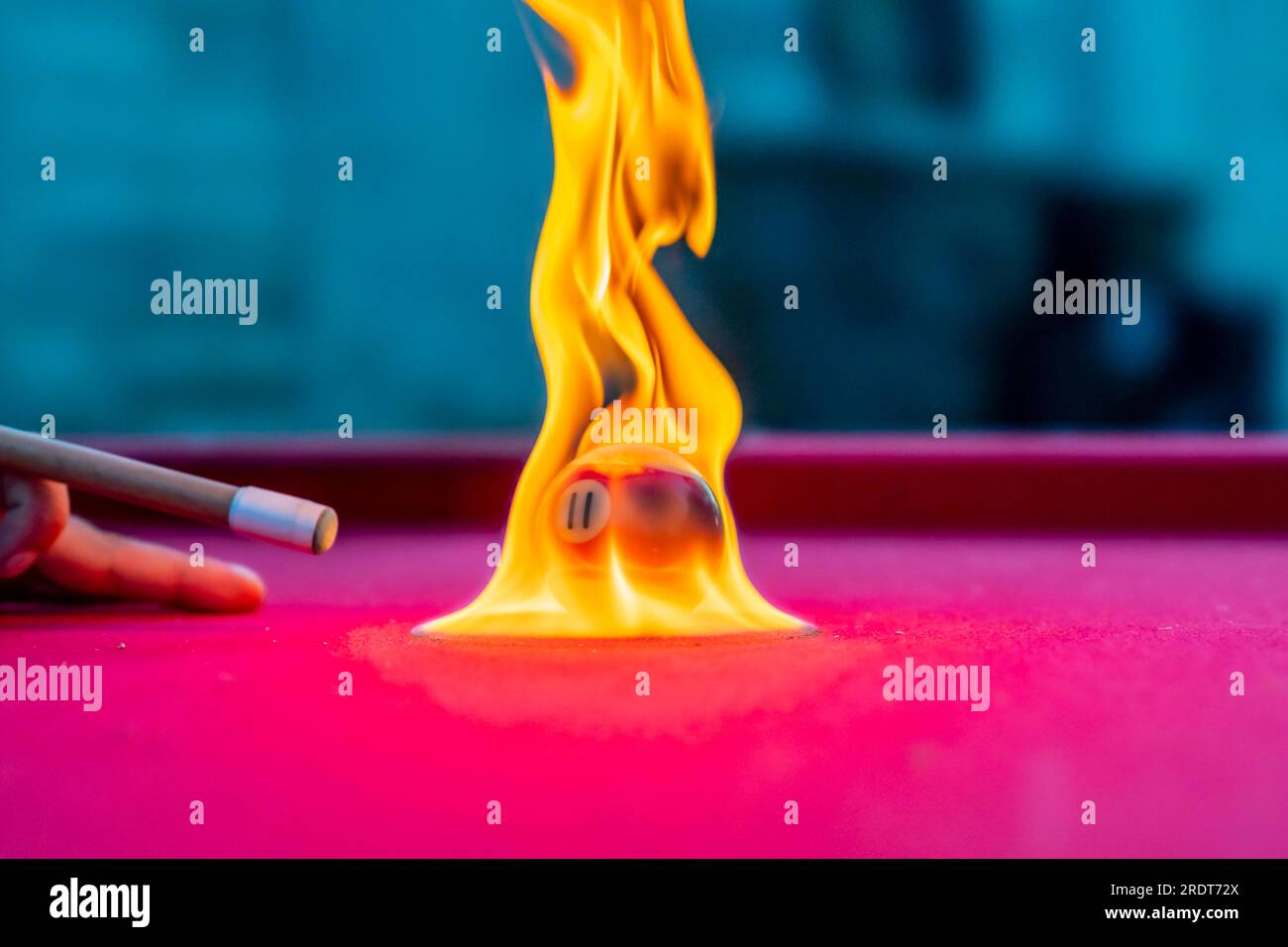 Billiard balls are photographed on fire while sitting outdoors in an ...