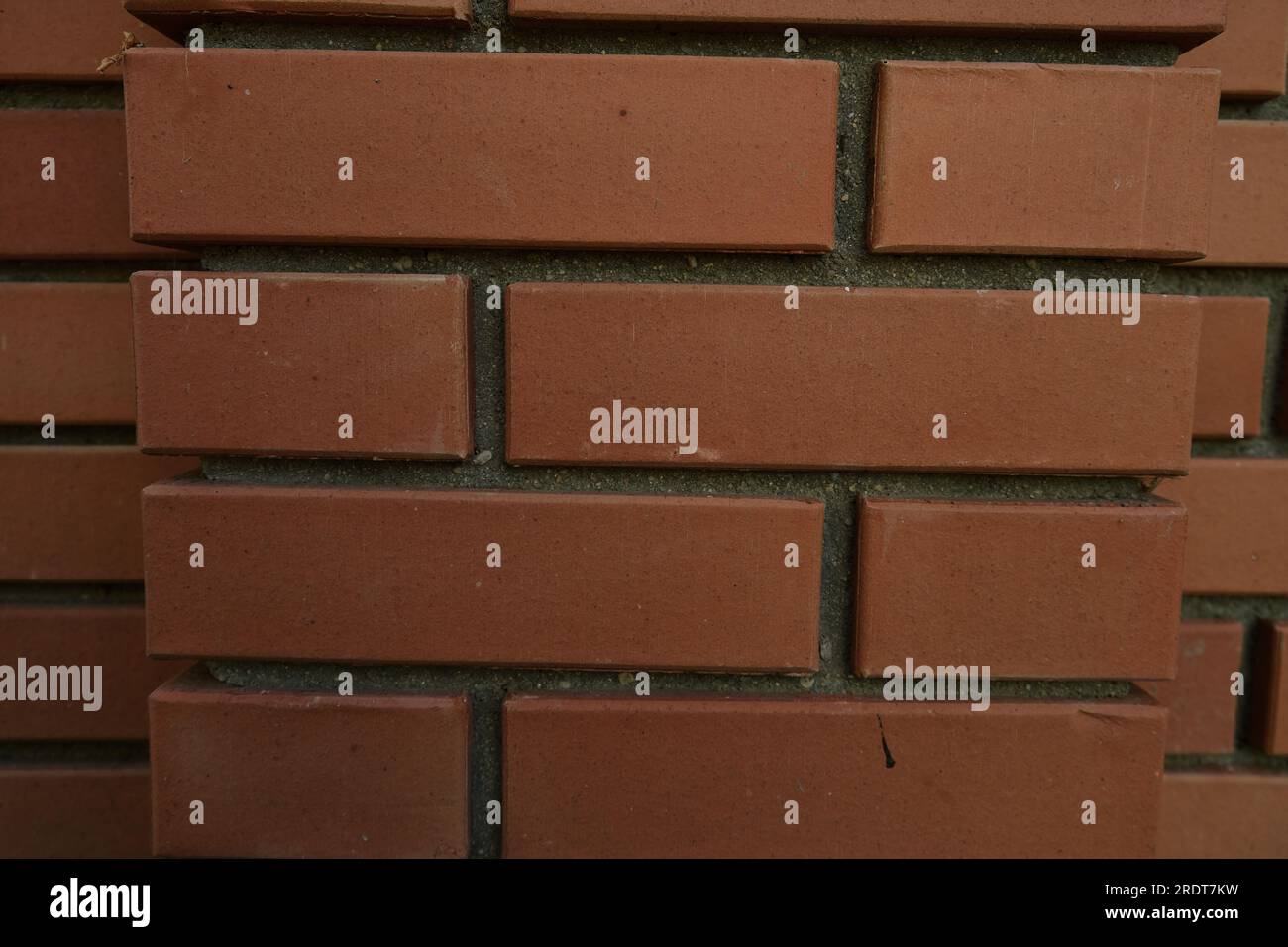 Red brick and brick edge from pillar in front of wall as texture ...