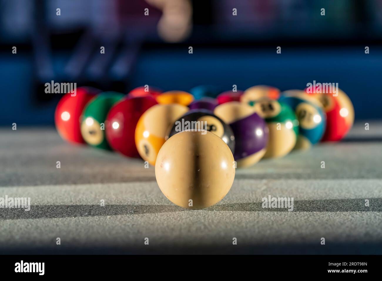 A racked up triangle of billiard balls on the table, ready for a game ...