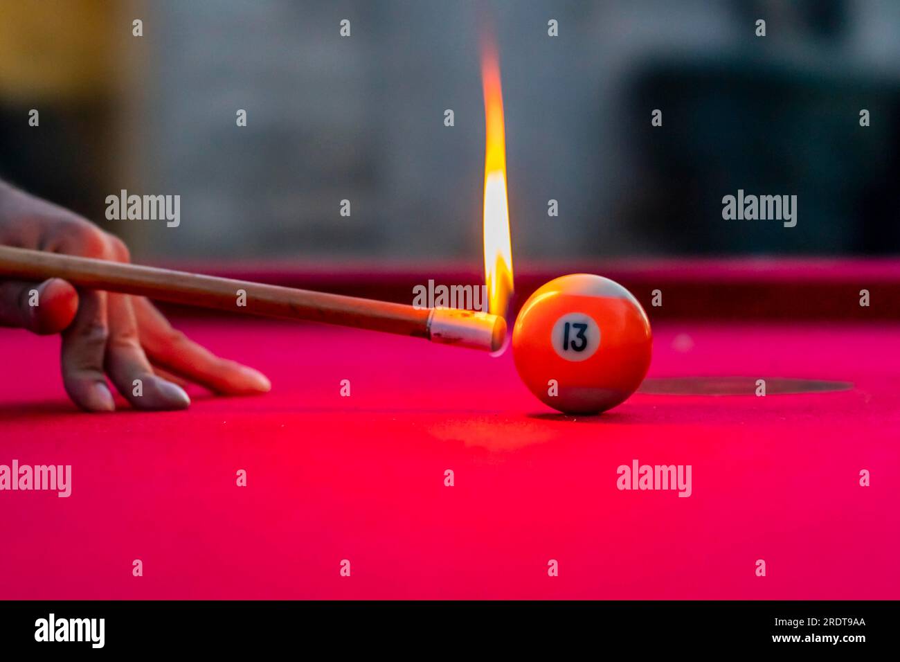 Billiard balls are photographed on fire while sitting outdoors in an ...