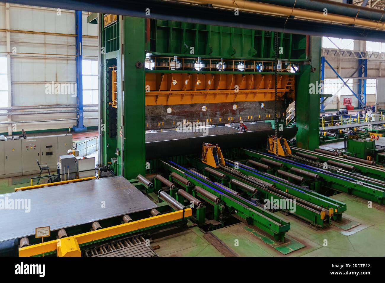 Pipe formation by roll sheet bending machine Stock Photo - Alamy