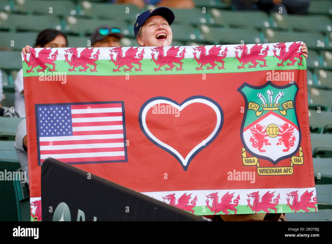 A soccer fan holds a flag during an international friendly soccer match ...