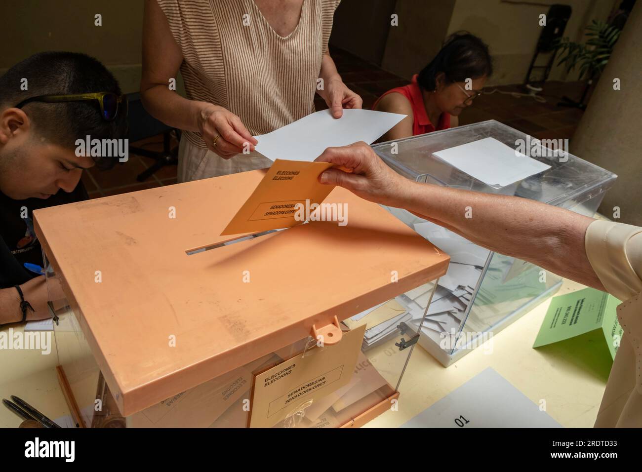 A female voter is seen entering her ballot at the polls. At 9:00 a.m ...