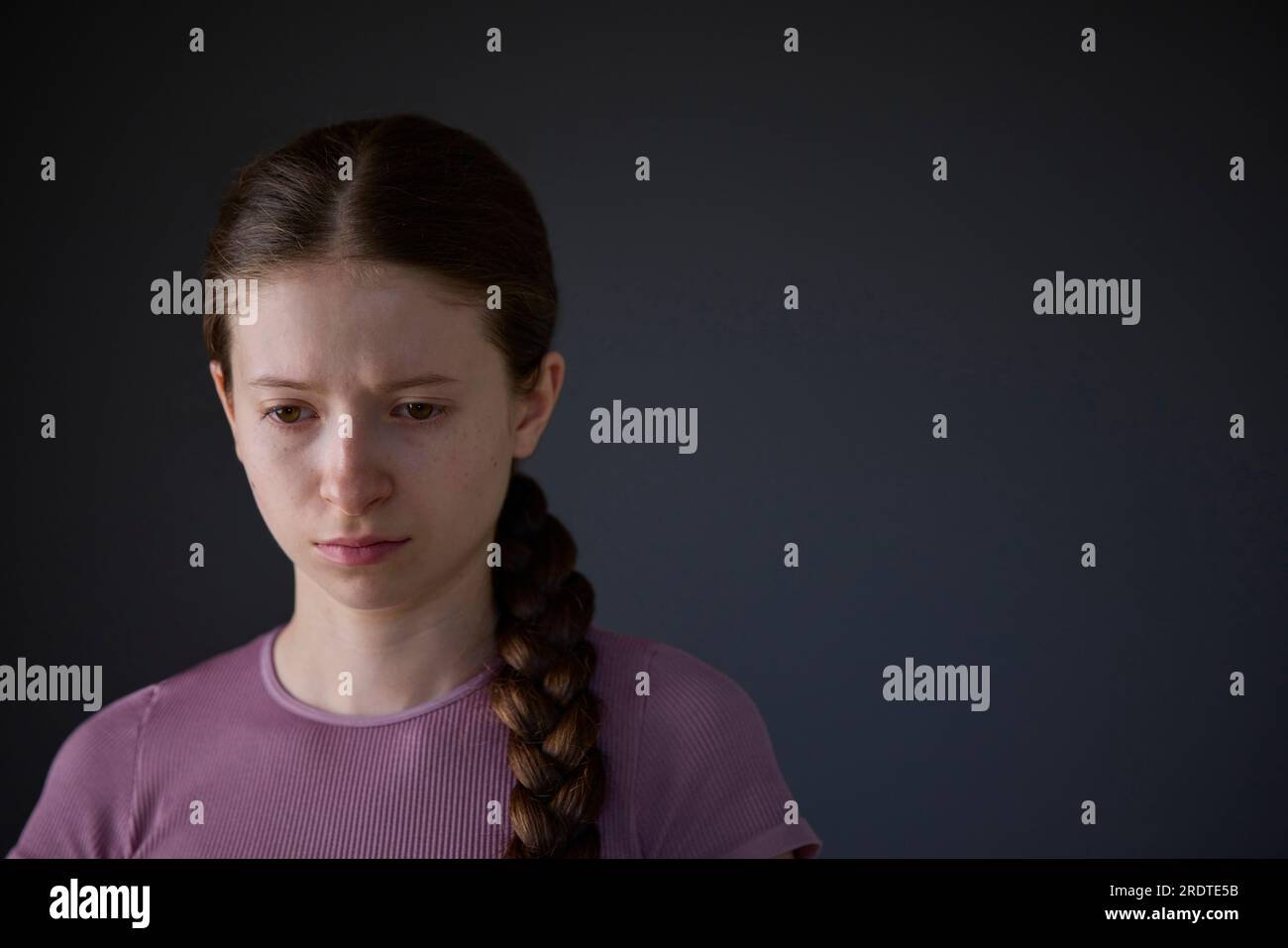 Low Key Studio Portrait Of Stressed Teenage Girl Worried About Mental ...