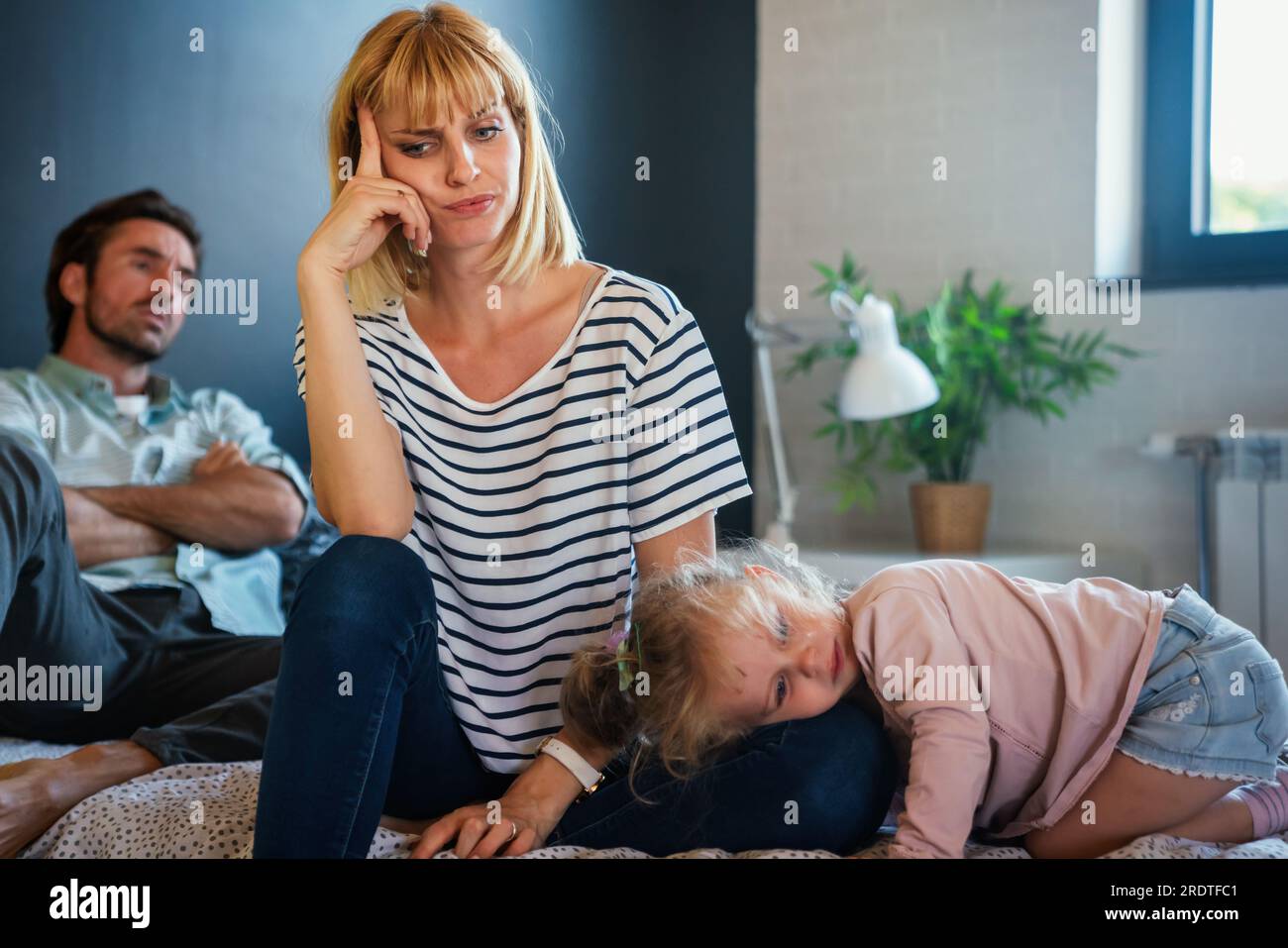 Tired mother and father sitting on couch feels annoyed exhausted ...