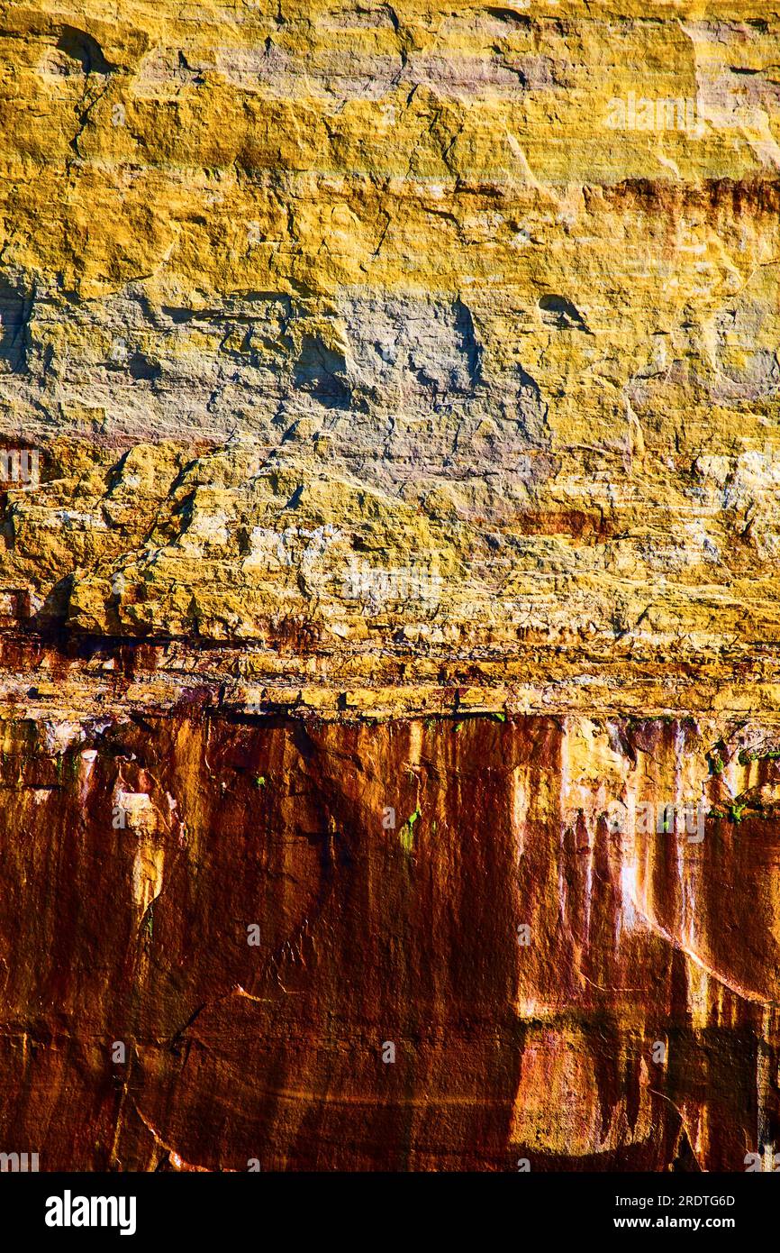 Yellow and rusty red drip down Pictured Rocks cliff wall like paint ...