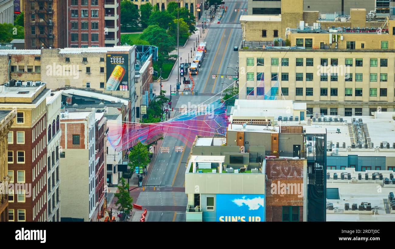 Pink and blue webbing stretching across buildings and street in ...