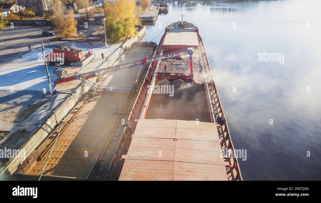 Loading wheat grain into barge, port and food industry grain silos in ...