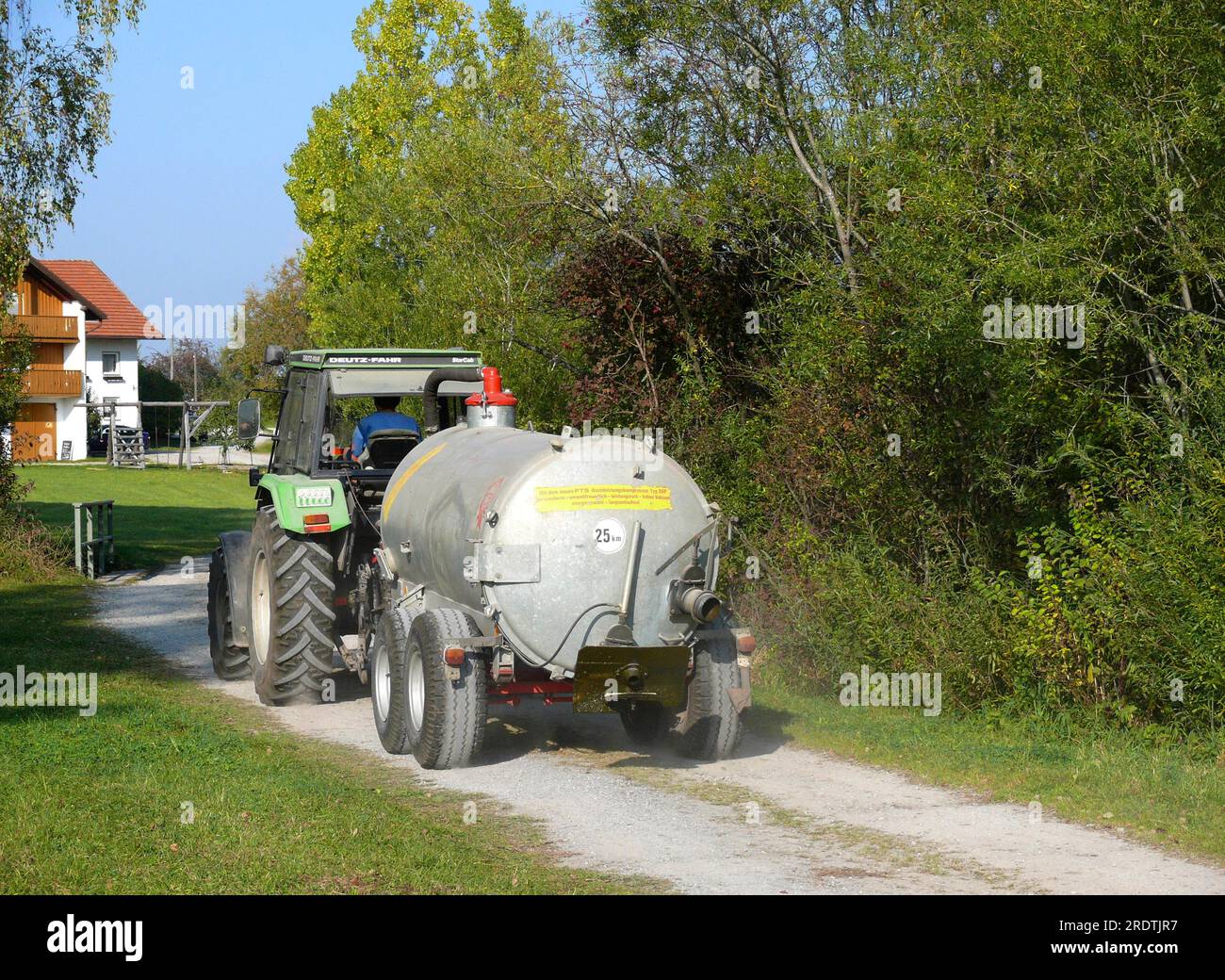 Farmer with tractor and slurry tanker, slurry tanker Stock Photo - Alamy