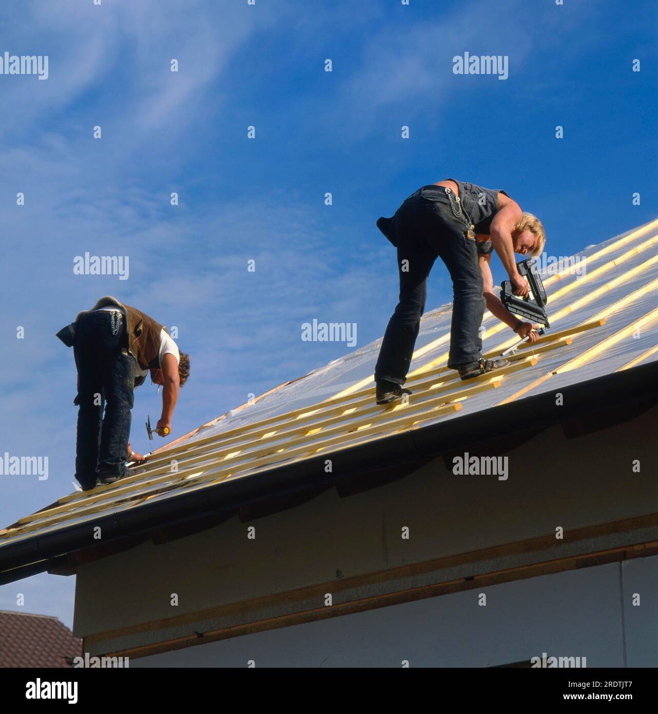 Carpenter on roof, prefabricated house, assembly Stock Photo - Alamy