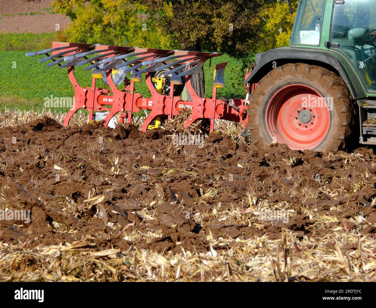 Tractor ploughing in autumn Stock Photo - Alamy