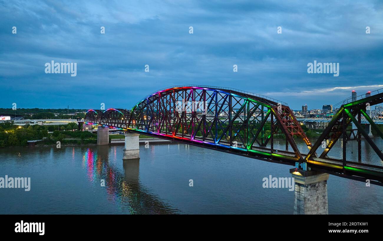 Rainbow pride illuminated bridge at night aerial over Ohio River ...