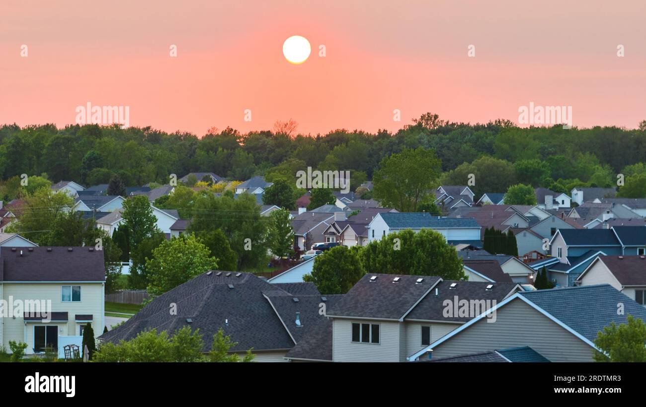 Green forest tree skyline aerial of sun rising setting over suburban ...