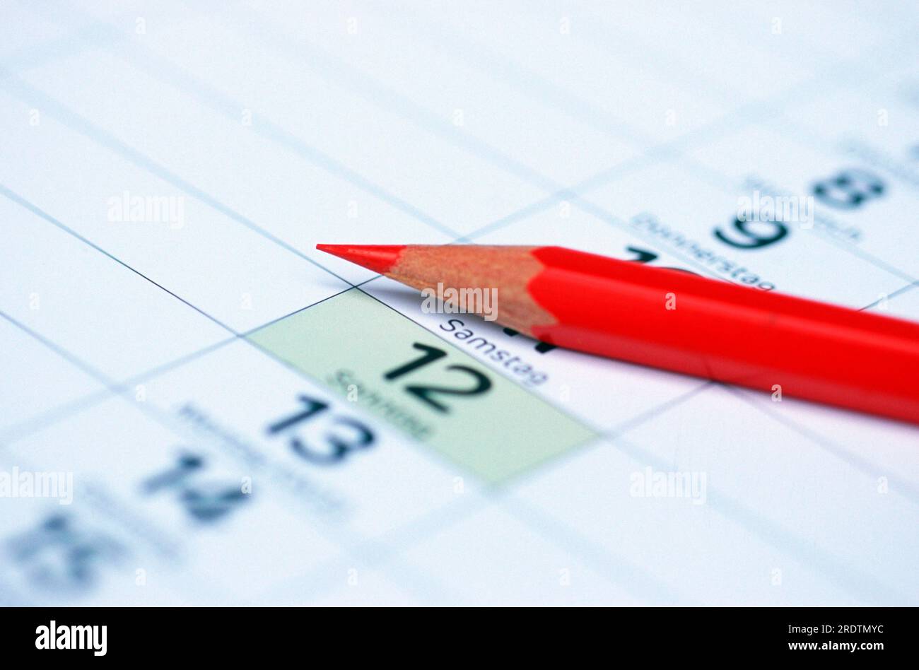 Red crayon and calendar Stock Photo - Alamy