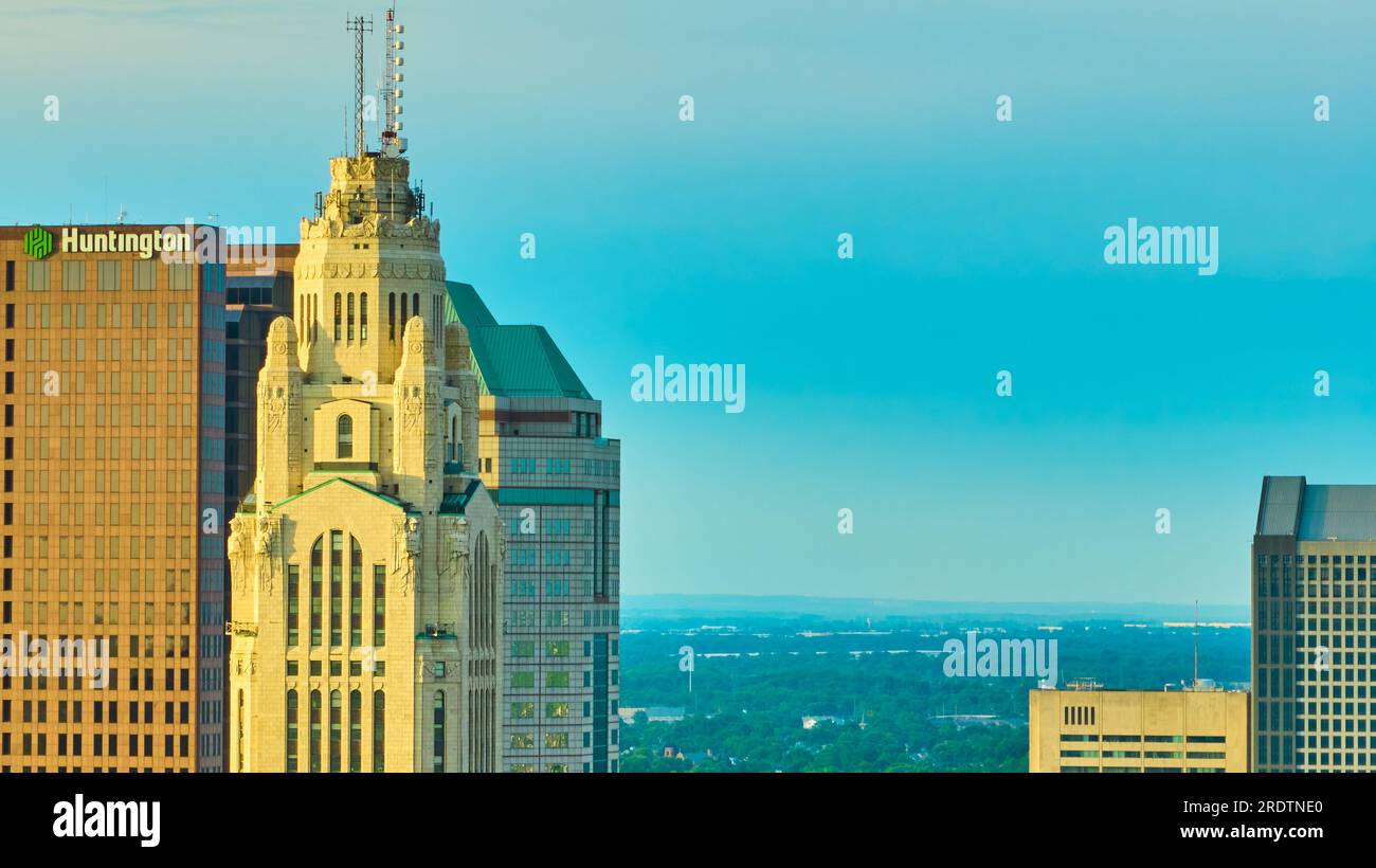 Aerial tip of LeVeque Tower at sunrise and other skyscraper tops behind ...